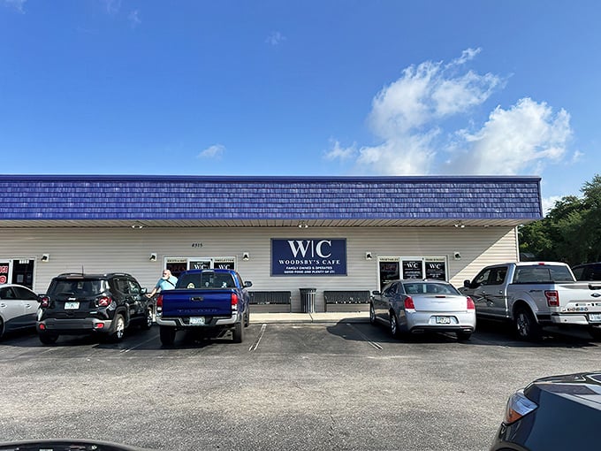 The unassuming exterior of Woodsby's Cafe might not scream "culinary destination," but locals know this blue-roofed treasure holds comfort food gold inside.