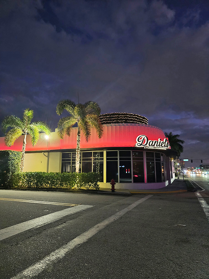 Art Deco elegance meets steakhouse sophistication at Daniel's, where the striking white exterior promises culinary adventures within. Palm trees included, no extra charge.