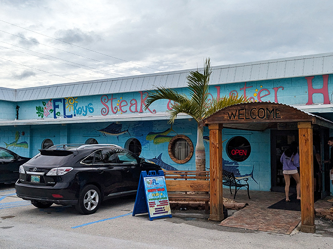 The vibrant turquoise exterior isn't just eye-catching&mdash;it's practically shouting "seafood paradise ahead!" through its nautical porthole windows.