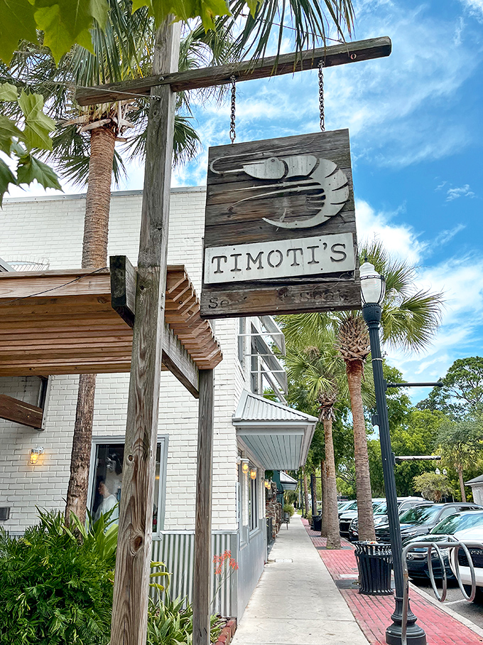 That weathered wooden shrimp sign swinging in the Florida breeze isn't just decoration&mdash;it's a beacon calling seafood lovers home to Timoti's charming Fernandina Beach location. 