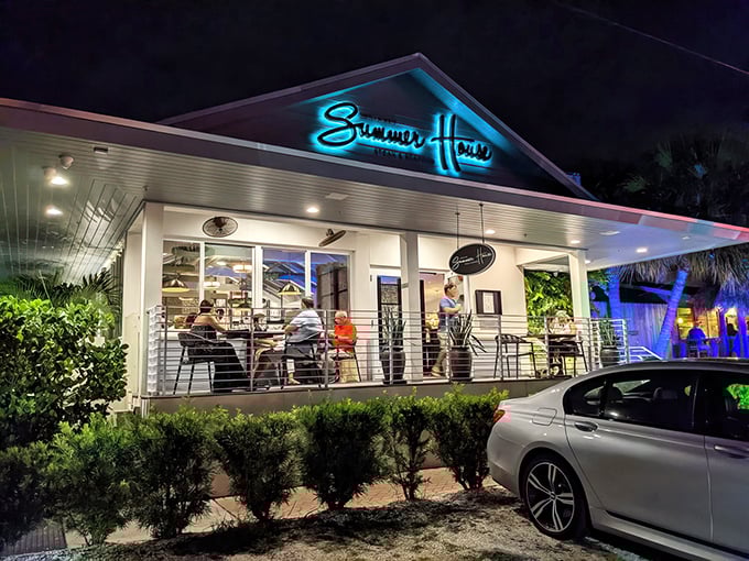 The coastal charm of Summer House beckons like an old friend, its crisp white exterior and lush landscaping promising culinary adventures within.