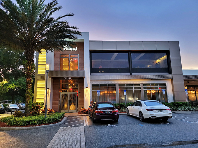 Modern elegance meets Florida charm at Del Frisco's exterior, where palm trees stand guard over what might be the best steak-eating decision of your life.