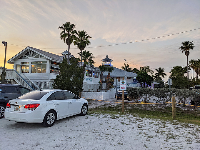 The iconic white lighthouse-topped entrance to Billy's Stone Crab beckons seafood lovers up those blue steps like a siren call to paradise.