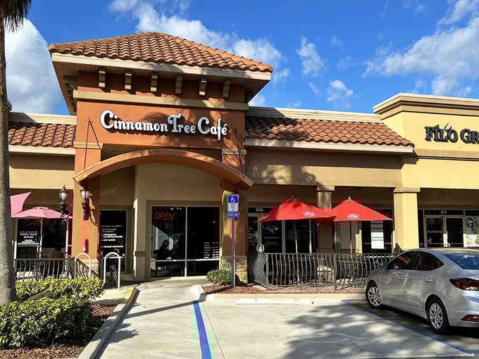 The unassuming strip mall exterior hides culinary treasures within, like finding a Picasso at a yard sale. Palm trees stand guard over flavor paradise.