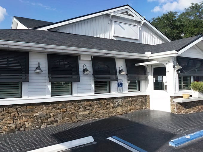 The iconic Sunset Grill sign welcomes hungry visitors with its cheerful sun logo, promising Florida warmth and hospitality before you even step inside.