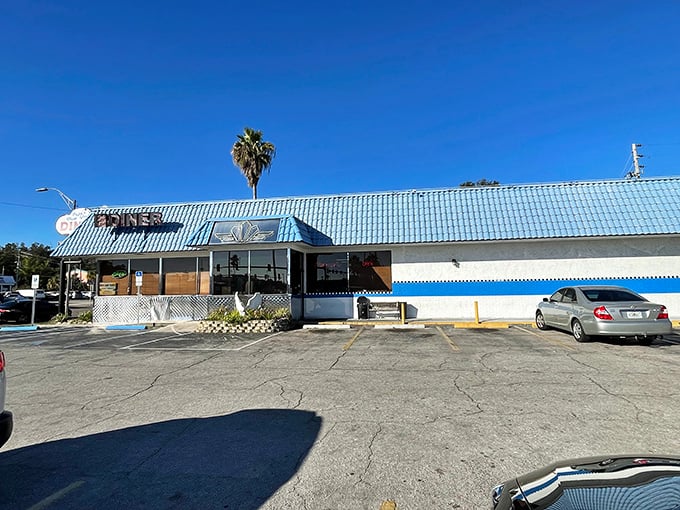 The iconic blue-roofed exterior of Papa's stands like a beacon for breakfast lovers, promising comfort food salvation under the Florida sun.