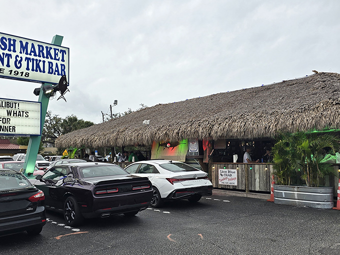 The thatched-roof tiki paradise beckons from the parking lot, promising seafood treasures and tropical escapes just steps away from everyday life.