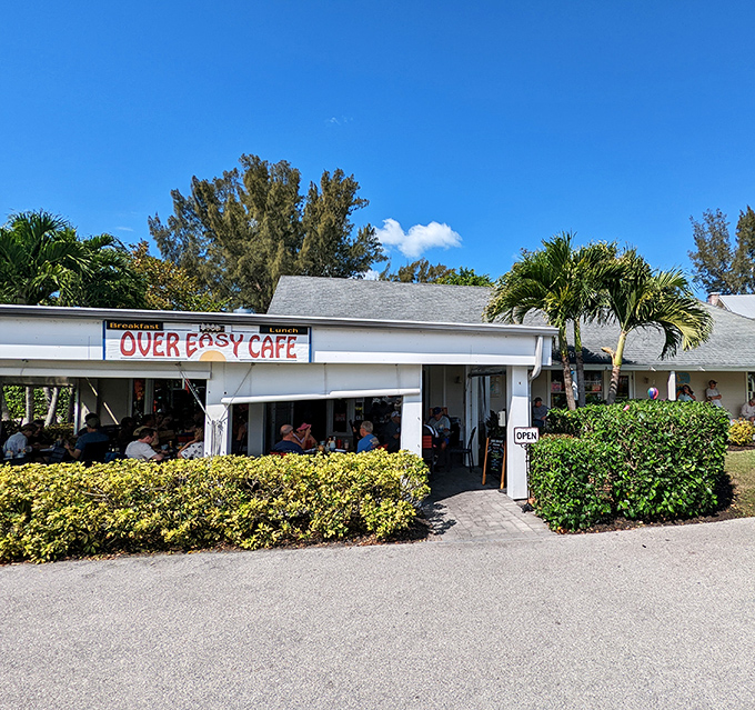 The unassuming exterior of Over Easy Cafe stands like a breakfast beacon on Sanibel Island, promising morning delights beneath the swaying palms.