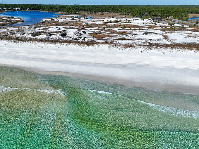 Nature's own masterpiece: where cotton candy skies meet emerald waters along a wooden boardwalk that practically begs you to kick off your shoes.