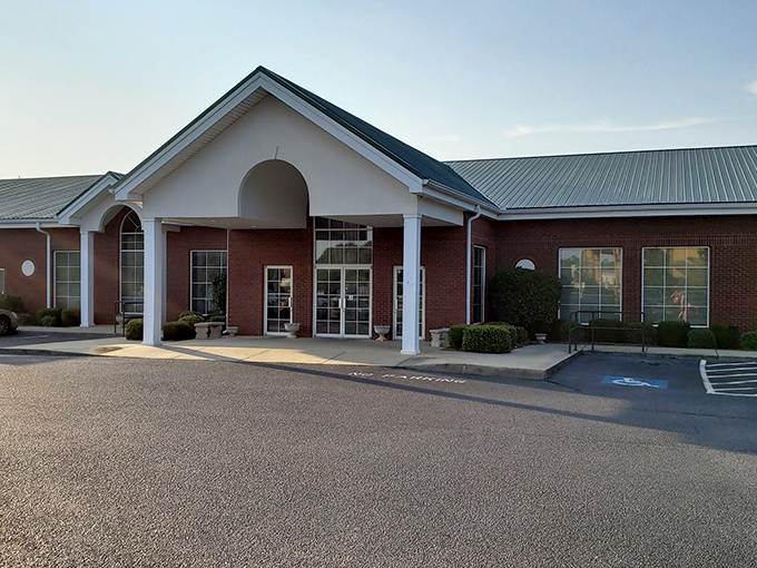 The welcoming brick exterior with its distinctive green roof promises comfort before you even step inside. Southern hospitality starts at the front door.