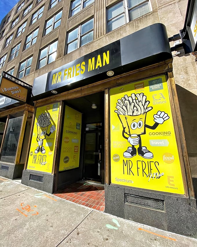 The bright yellow storefront stands out like a beacon of potato promise, with the cartoon fry mascot practically waving you inside.