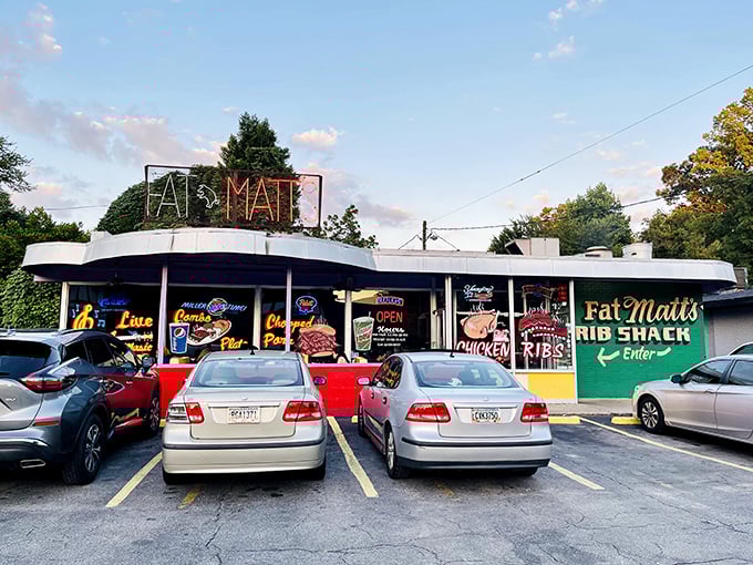 The neon "FAT MATT'S" sign glows like a barbecue beacon against the twilight sky, promising smoky salvation to hungry Atlanta souls.