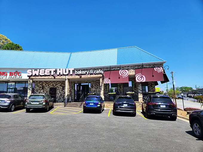 The distinctive blue roof and stone facade of Sweet Hut beckons like a beacon of baked goodness in Doraville's culinary landscape.
