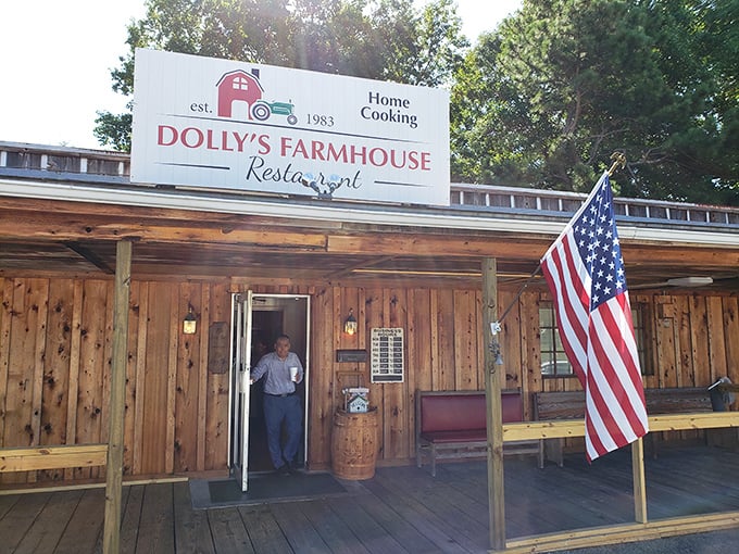 The rustic wooden exterior of Dolly's Farmhouse Restaurant promises authenticity before you even step inside. That American flag isn't just decoration&mdash;it's a guarantee.