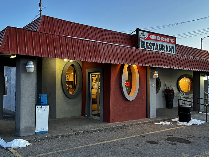 The iconic red-roofed diner with porthole windows stands like a culinary lighthouse for hungry travelers seeking comfort food perfection in Idaho Falls.