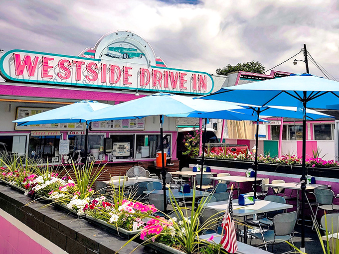 The pink and turquoise facade of Westside Drive In stands like a time capsule of Americana, beckoning hungry travelers with promises of comfort food perfection.
