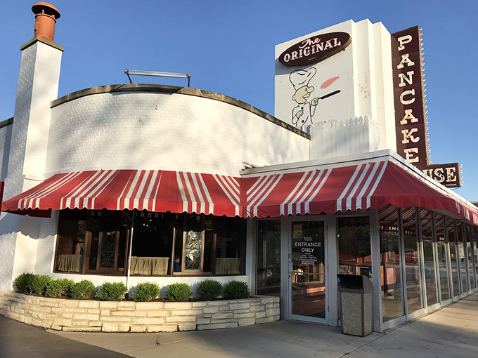 The iconic white building with red-and-white awnings stands like a breakfast beacon, calling hungry pilgrims from across Illinois to pancake paradise.