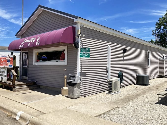 The pink awning of Smitty's beckons like a neon promise in rural Illinois—small-town charm with big-time flavor waiting just beyond that door.