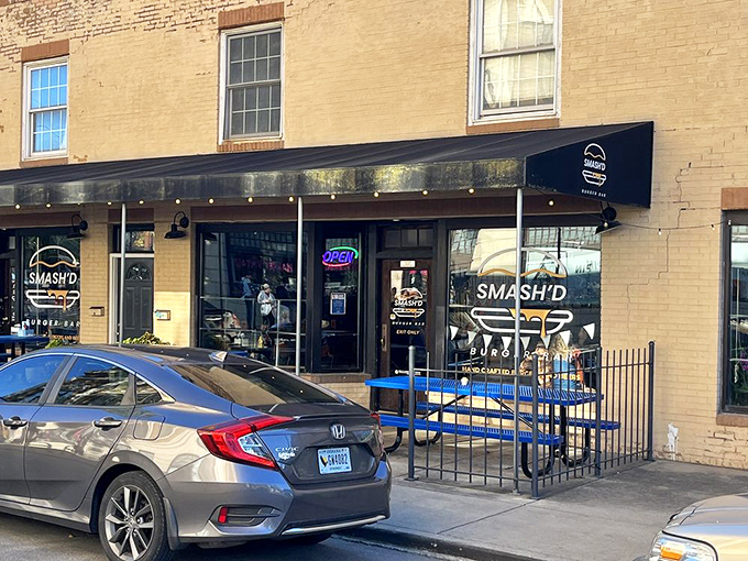 The bright blue picnic tables outside Smash'd Burger Bar are like a beacon calling to hungry travelers. No pretension here, just the promise of honest-to-goodness flavor.