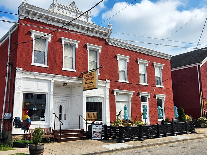 The stately red brick exterior of Wagner's Village Inn stands as a beacon of culinary tradition in Oldenburg, complete with a welcoming rooster sentinel.