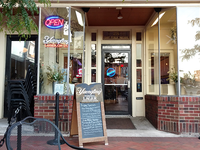 The unassuming storefront of Monument Pizza Pub beckons hungry travelers with its vintage charm and promise of pizza perfection in downtown Angola.