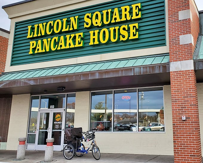 The iconic green and yellow sign beckons hungry travelers like a breakfast lighthouse guiding morning-starved sailors to pancake paradise.