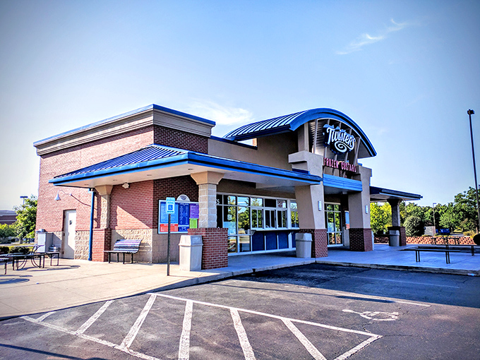 Twisters stands like a beacon of dairy delight with its distinctive curved blue roof, practically whispering sweet promises to passersby.