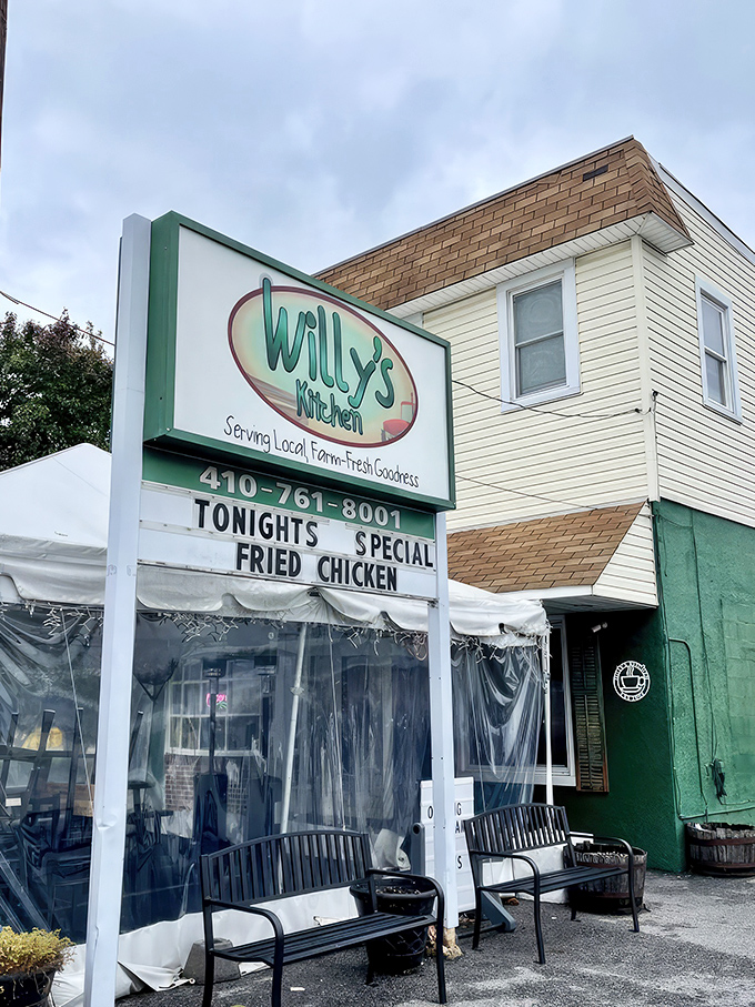 Willy's Kitchen stands proudly in Glen Burnie, its mint-green exterior and vibrant flower boxes promising comfort food treasures within. The sign's special announcement of fried oysters is just a bonus.