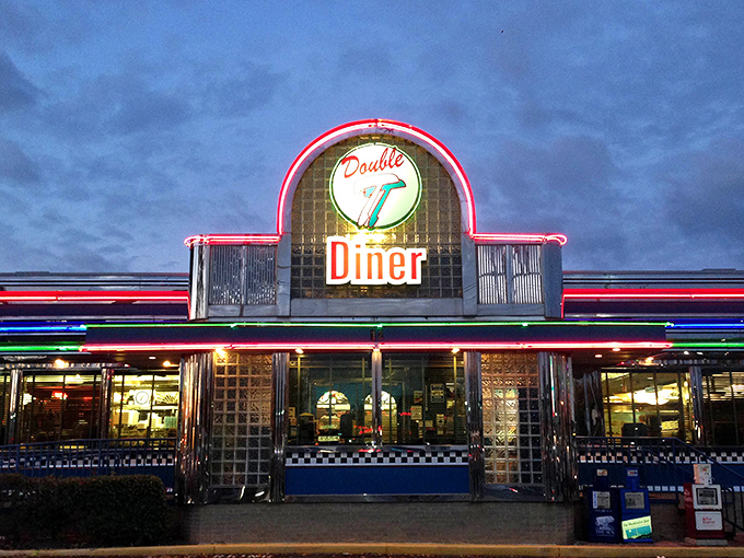 The Double T's neon sign glows like a beacon of comfort food against the twilight sky, promising delicious salvation for hungry travelers.