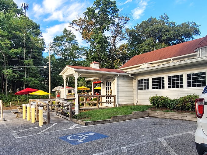 The unassuming exterior of The Hideaway belies the culinary treasures within. Those colorful umbrellas are like beacons calling hungry travelers home.