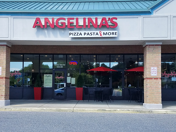 The bright red signage beckons like a lighthouse for the pasta-starved. Come for the promise of "Pizza Pasta & More," stay for the red umbrella charm.
