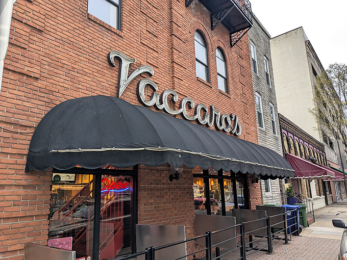 The corner brick building stands like a sentry guarding Little Italy's sweetest treasures, its black awnings a beacon for dessert pilgrims.