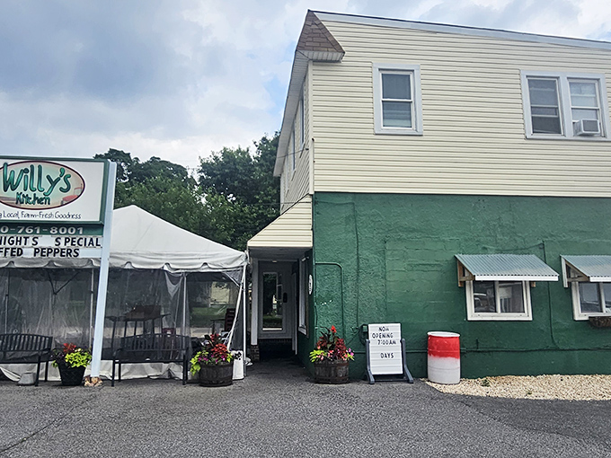 The unassuming exterior of Willy's Kitchen proves once again that the best food often hides behind the most modest facades. That sign promises fried chicken glory!