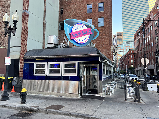 The iconic blue coffee cup sign beckons hungry souls to South Street Diner like a neon lighthouse in Boston's brick-lined Leather District.