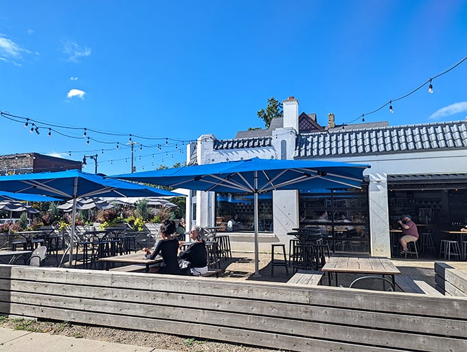 Twilight transforms this former service station into a magical oasis, where string lights and happy diners create the perfect Michigan summer evening vibe.