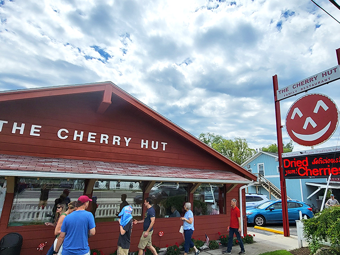 The Cherry Hut's cheerful red exterior isn't just a building&mdash;it's a promise of the ruby delights waiting inside. Complete with Cherry Jerry mascot standing guard!