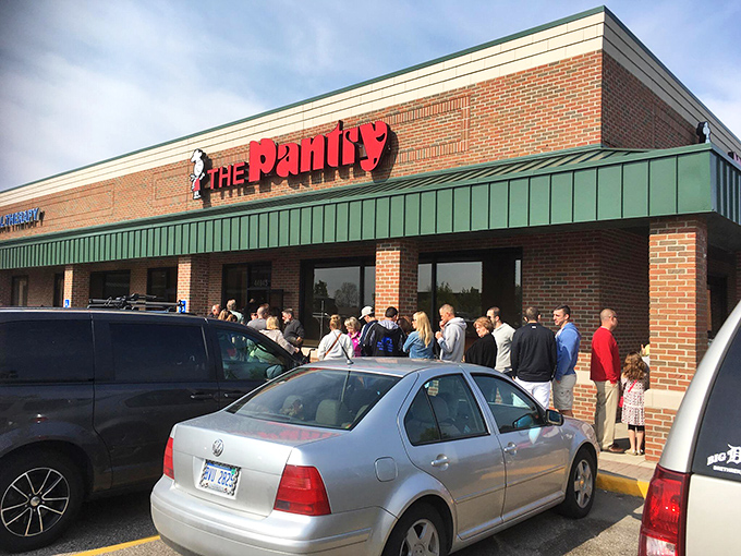 The unassuming exterior of The Pantry Restaurant, where breakfast dreams come true and parking spots are worth their weight in maple syrup.