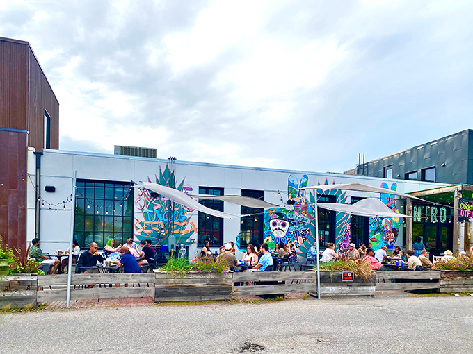 Centro's neon sign glows like a turquoise beacon against the twilight sky, promising Mexican delights in Northeast Minneapolis's urban landscape.