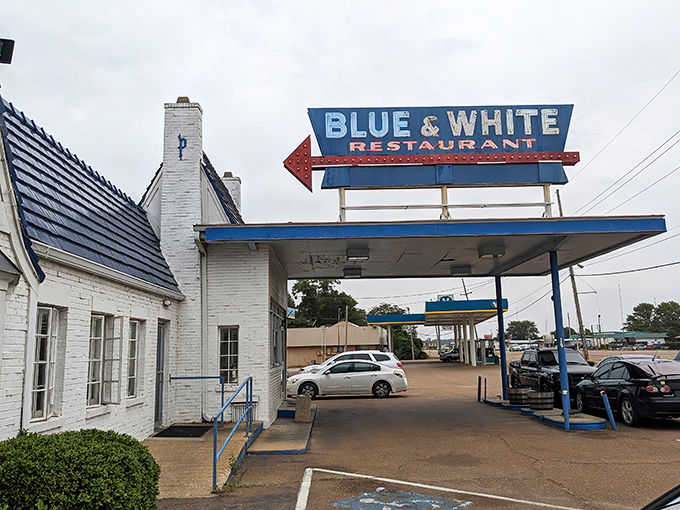 The iconic Blue & White Restaurant stands as a time capsule of Americana, its vintage gas station canopy beckoning hungry travelers along Highway 61.