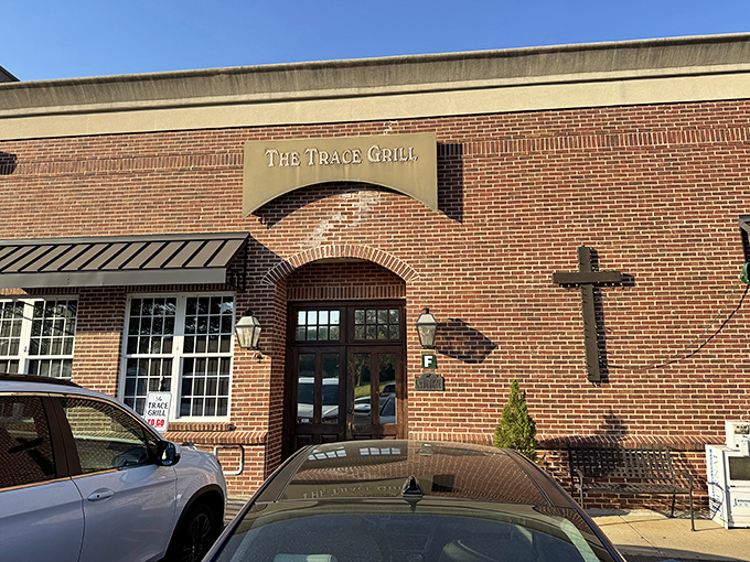 The unassuming brick exterior of The Trace Grill hides culinary treasures within, like a Southern speakeasy where the password is "comfort food."