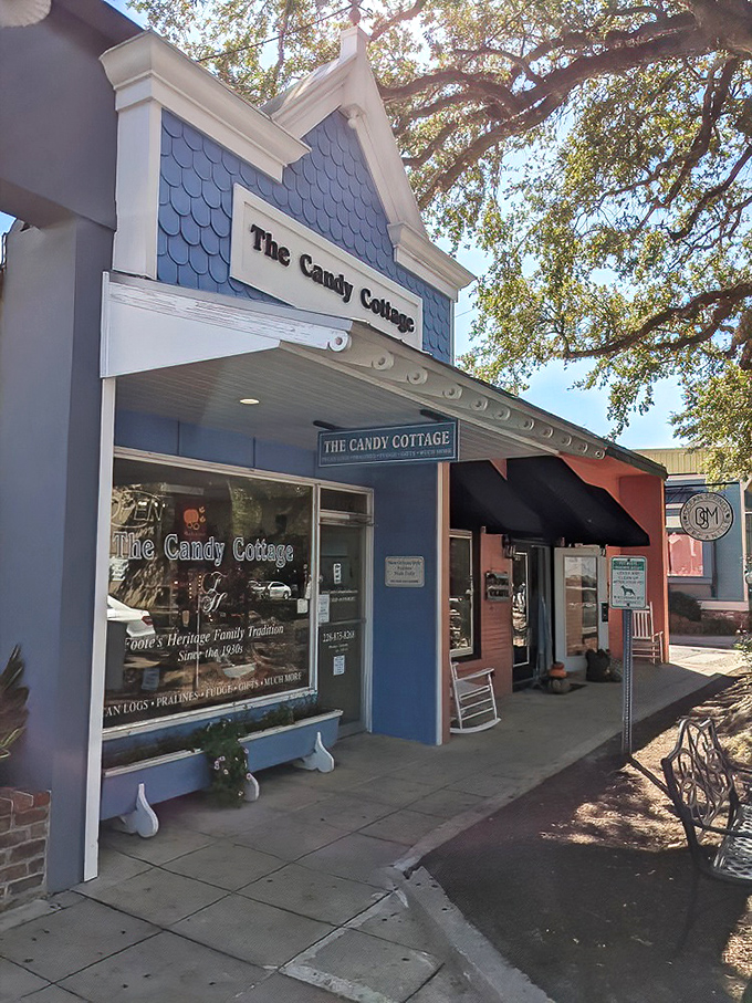 The blue cottage beckons like a sweet mirage among Ocean Springs' oak trees, promising childhood memories and sugar-fueled adventures inside.