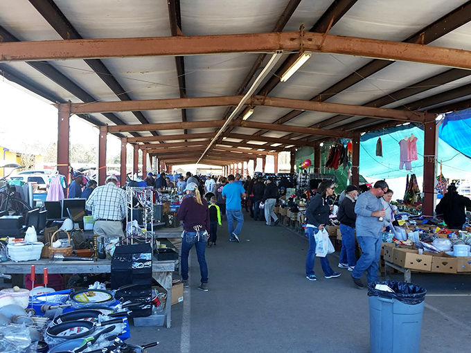 The red "FLEA MARKET" sign beckons like a siren call to bargain hunters. Treasure awaits under this bustling pavilion in Pass Christian.