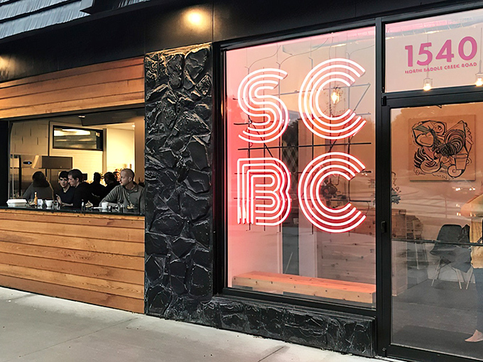 That neon pink SCBC sign glows like a breakfast beacon, promising morning salvation to hungry Omahans seeking refuge from ordinary eggs.