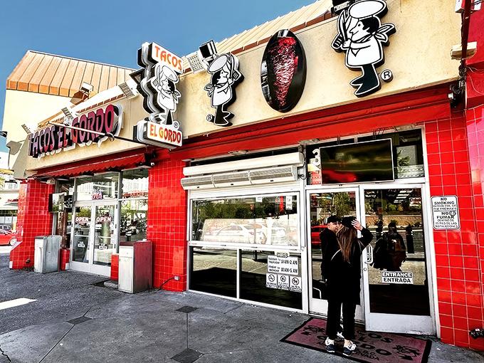 The vibrant red exterior of Tacos El Gordo stands out like a beacon of hope for hungry souls wandering the Las Vegas desert.