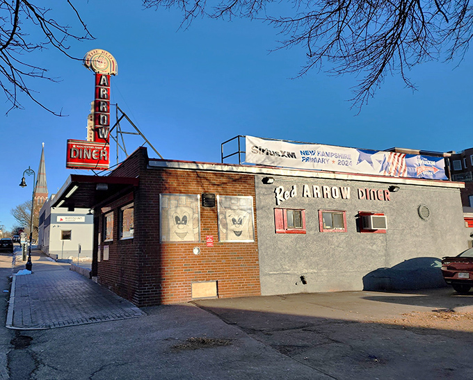 The iconic neon sign beckons hungry travelers like a lighthouse for the famished. This brick-and-mortar time machine has been Manchester's comfort food headquarters for generations.