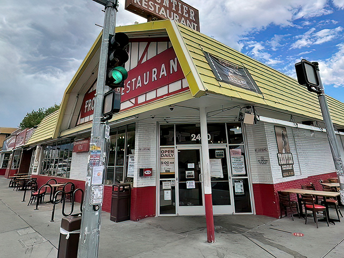 The iconic white and red exterior of Frontier Restaurant stands like a beacon of breakfast hope on Central Avenue, drawing hungry pilgrims daily.