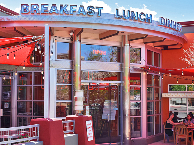 The iconic red exterior of Range Cafe beckons hungry travelers with its bold "BREAKFAST LUNCH DINNER" promise&mdash;a siren song for comfort food enthusiasts.