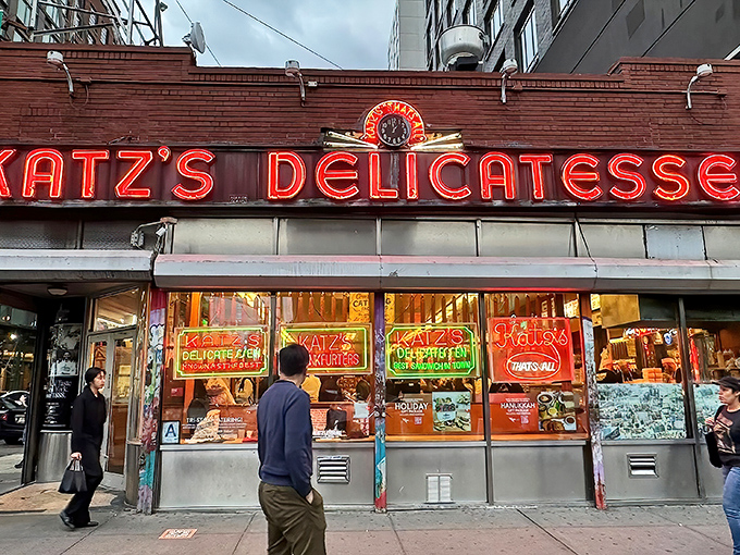 The iconic neon sign of Katz's Delicatessen glows like a beacon for hungry souls on Houston Street, a timeless landmark in a constantly changing city.