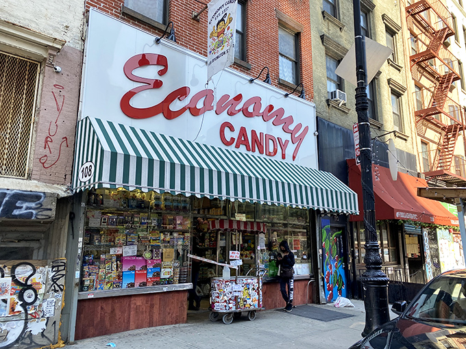 The iconic red cursive sign of Economy Candy beckons sugar-seekers like a lighthouse for sweet-toothed sailors navigating the Lower East Side.