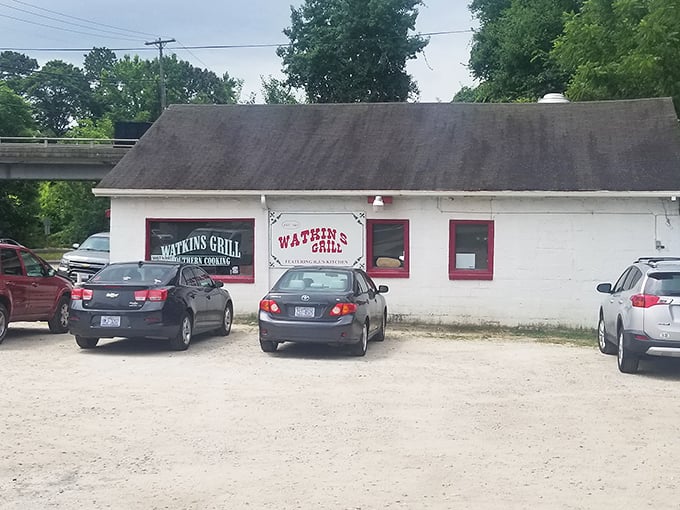 The unassuming white exterior of Watkins Grill stands as a beacon of breakfast hope on Wake Forest Road, where culinary magic happens without fanfare.